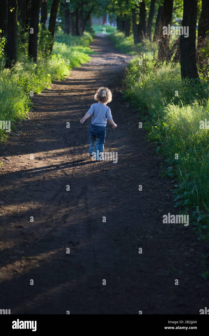 Child on country path Stock Photo - Alamy