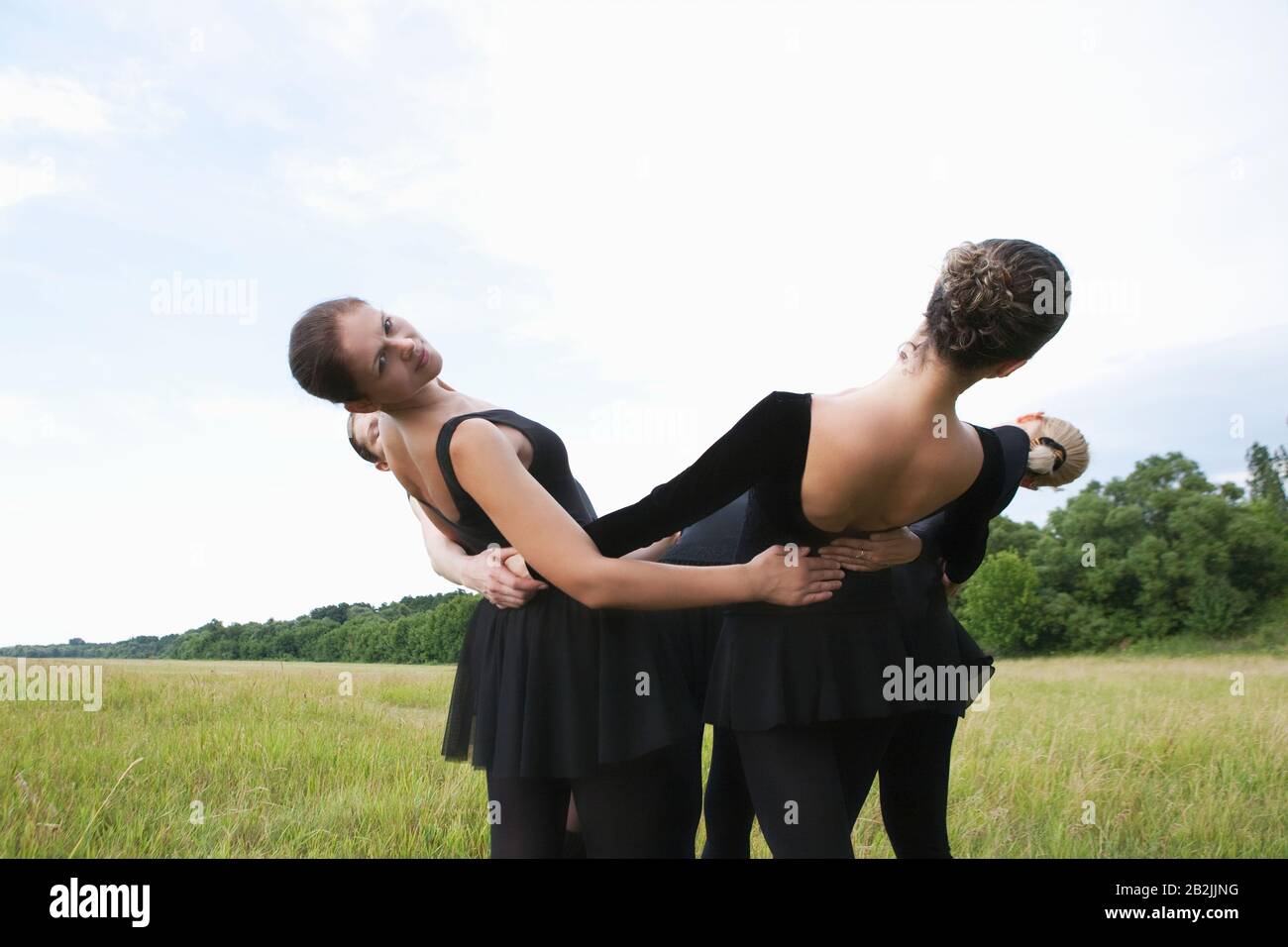 Young women support each other and lean backwards Stock Photo - Alamy