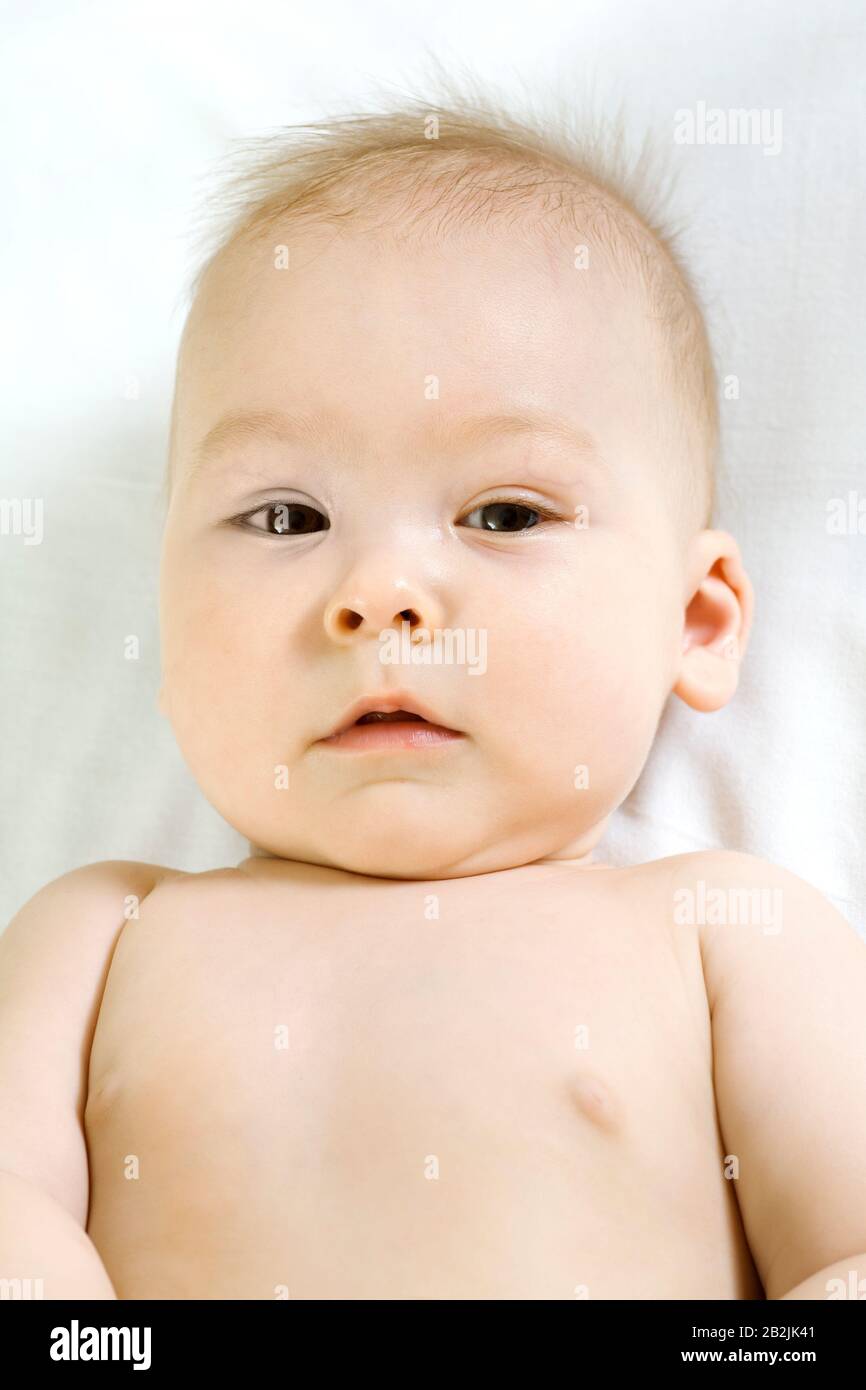 Infant child lying on back Stock Photo - Alamy