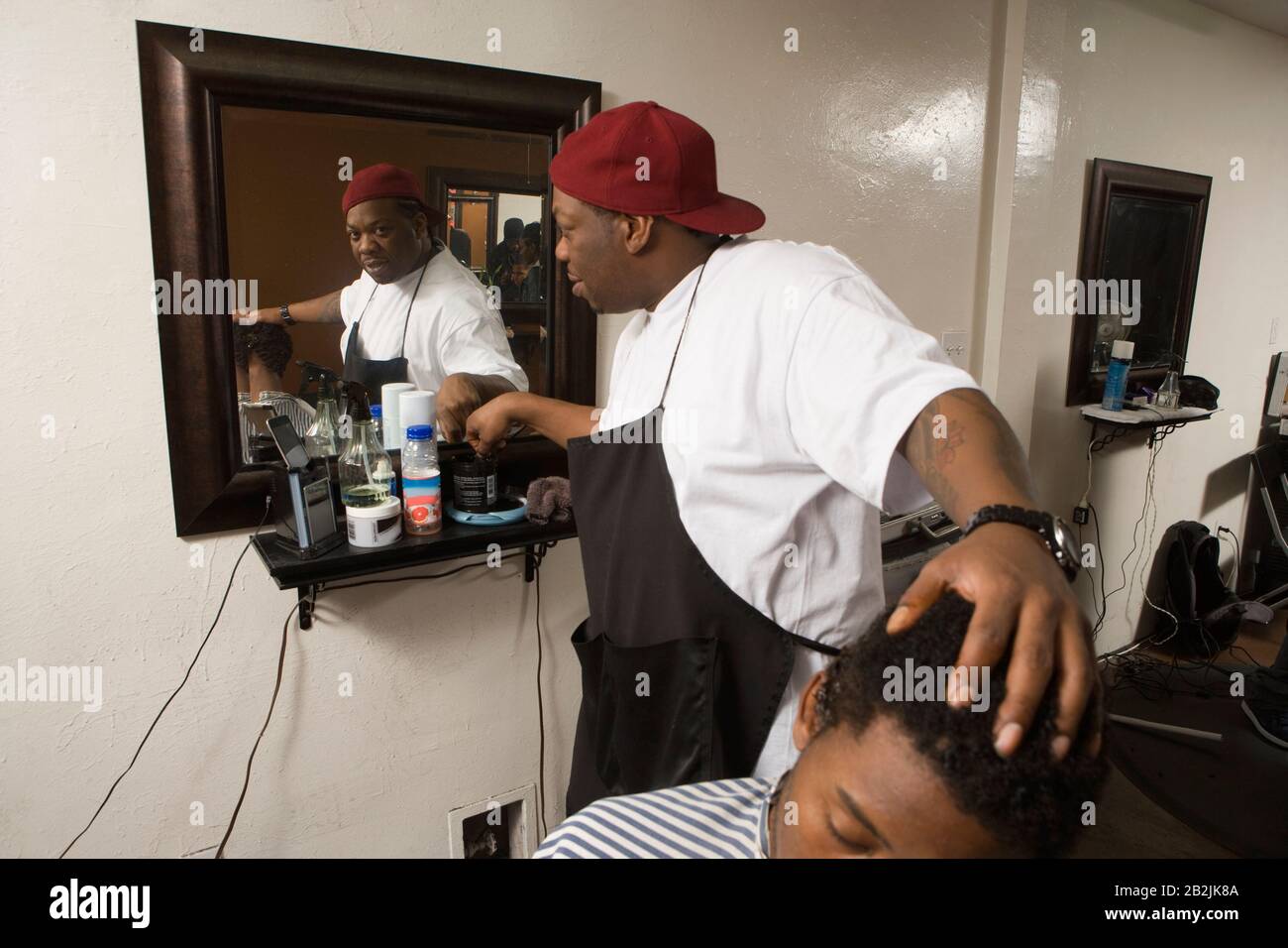 A young man having his hair done in the barbers Stock Photo - Alamy