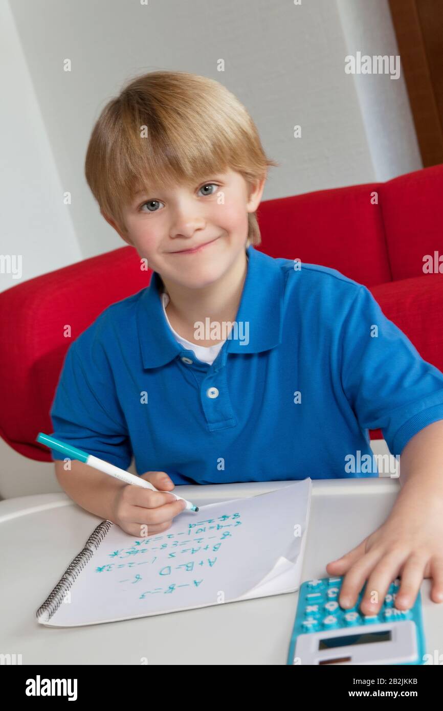 Portrait of little boy doing homework Stock Photo - Alamy