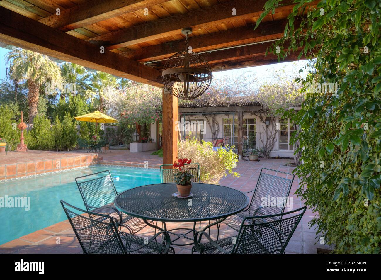 Table and chair at poolside in mansion Stock Photo - Alamy