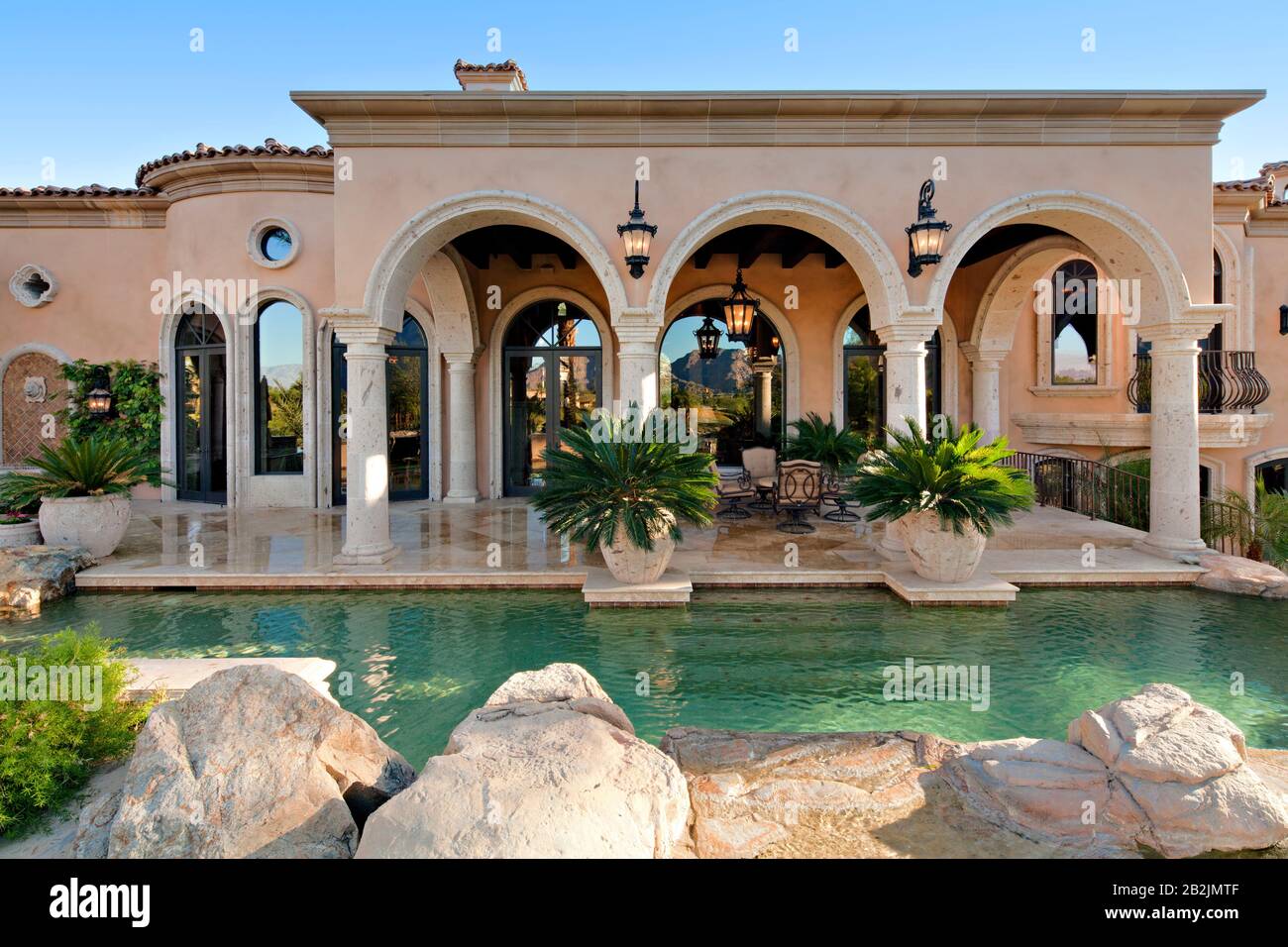 Swimming pool in foreground of manor house Stock Photo - Alamy