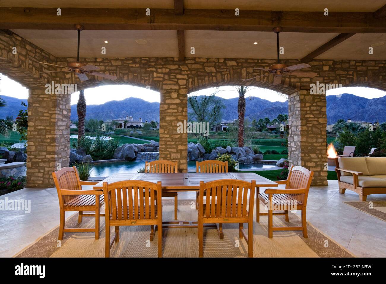 Dining table and chair in patio of luxury villa Stock Photo - Alamy