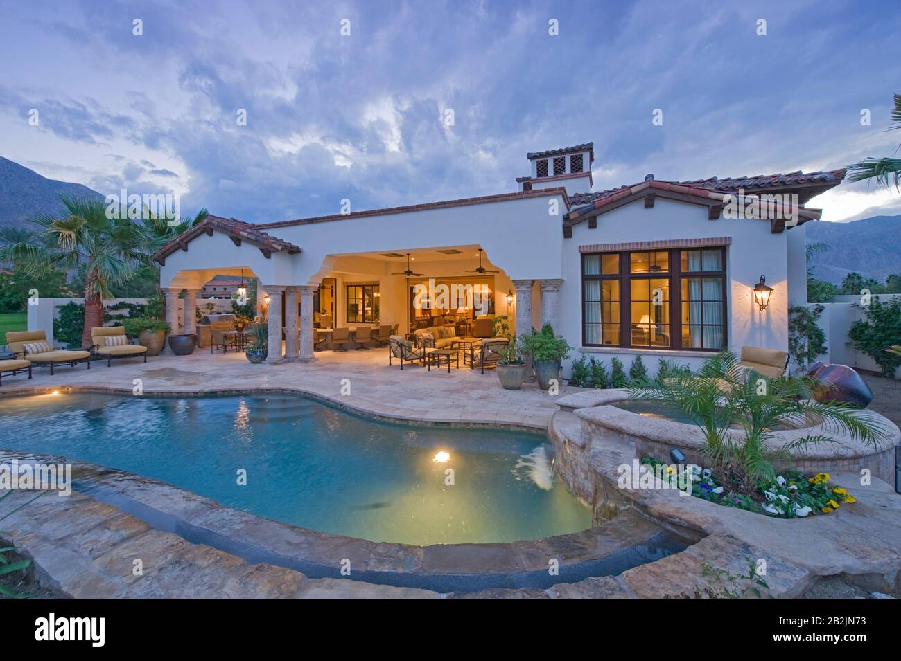 Swimming pool in front of luxury mansion Stock Photo - Alamy