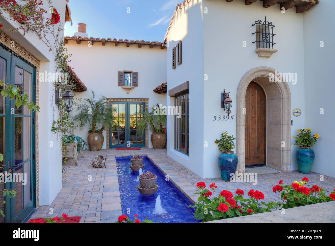 Fountain in front courtyard of luxury manor house Stock Photo - Alamy