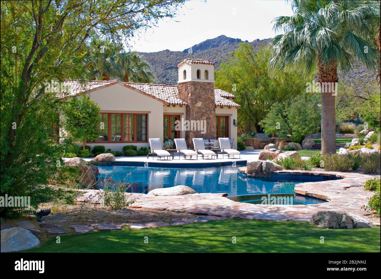 Sun loungers at poolside in luxury mansion Stock Photo - Alamy