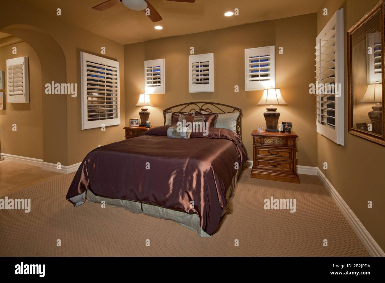 Luxurious bedroom with comfortable bed in mansion Stock Photo - Alamy