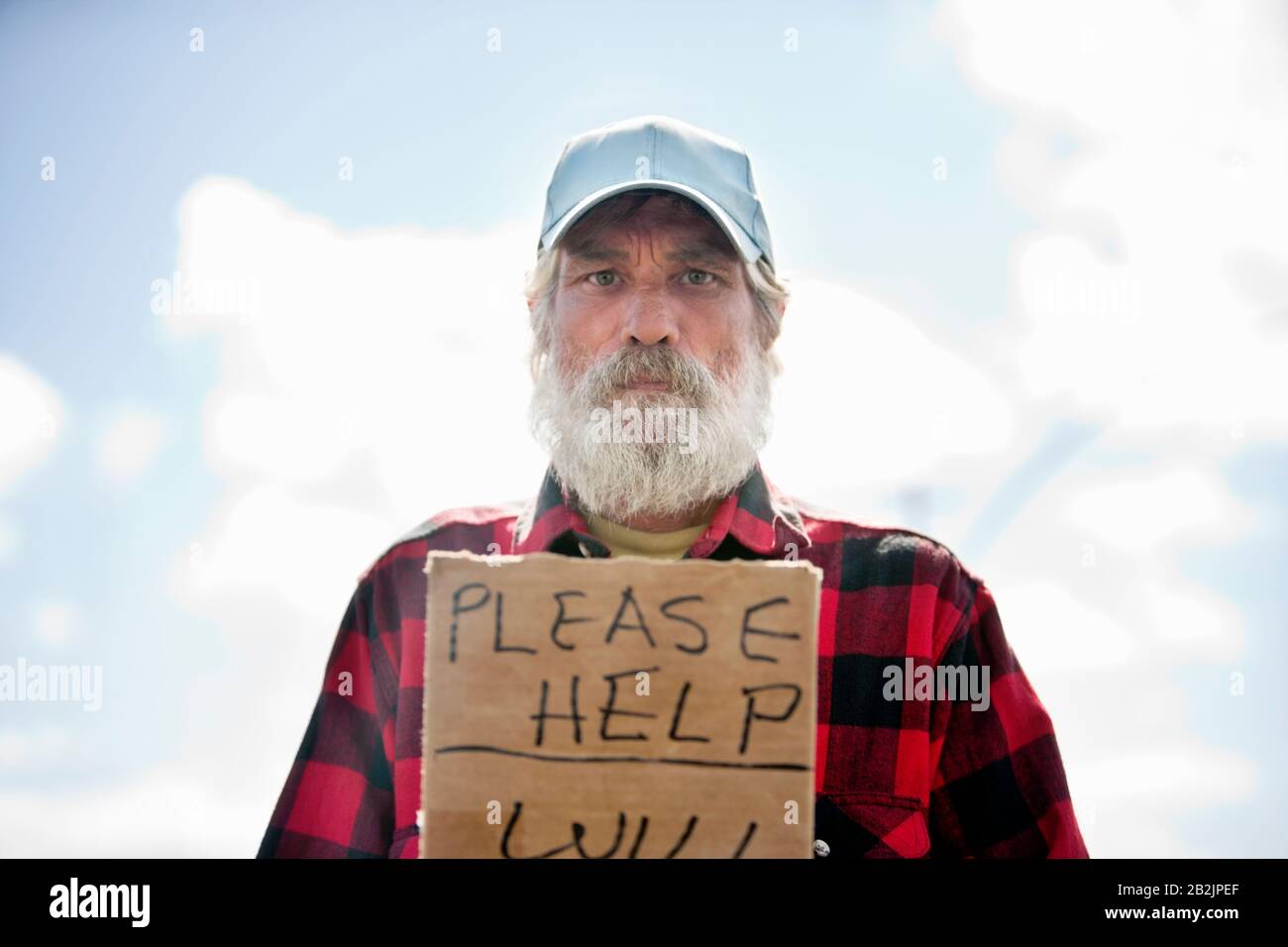 Portrait of a homeless person with sign Stock Photo - Alamy