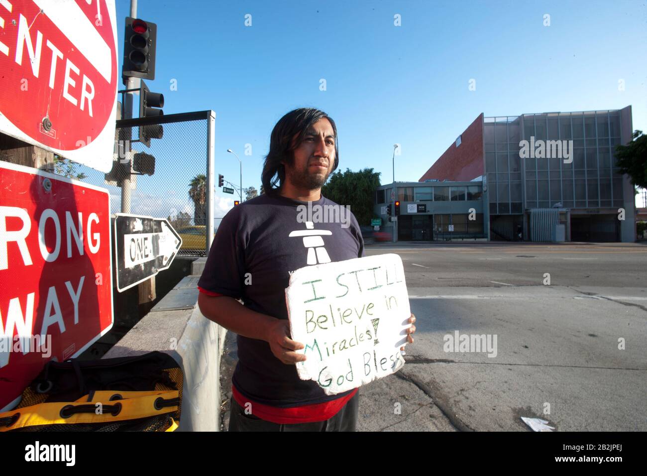 Homeless person with placard standing on street Stock Photo - Alamy