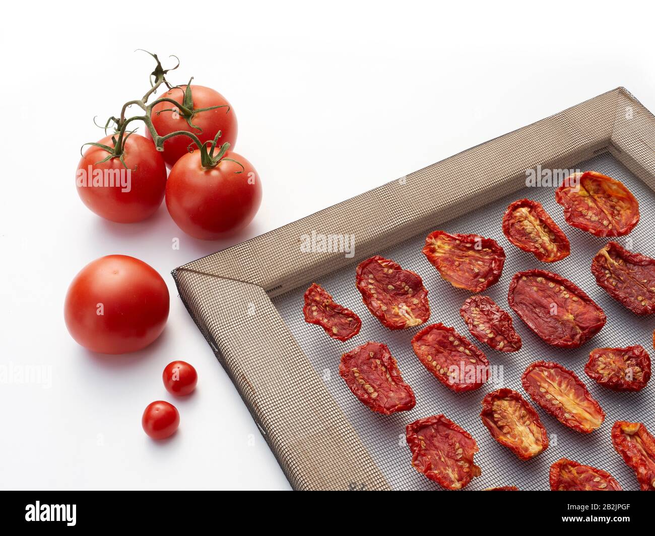 Sun Dried tomatoes in the sunshine on white Stock Photo - Alamy