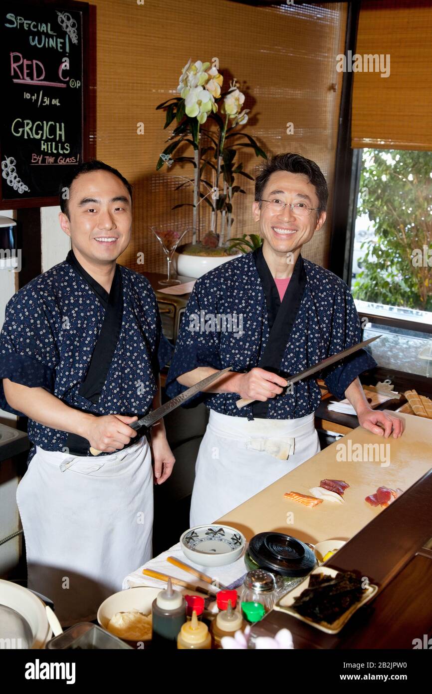 Portrait of Asian chefs preparing sushi together Stock Photo - Alamy
