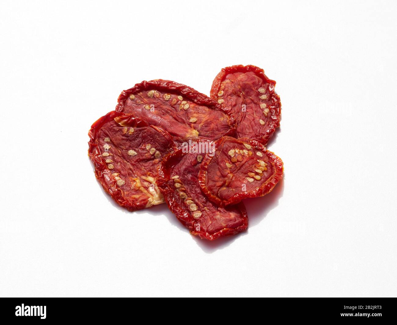 Sun Dried tomatoes in the sunshine on white Stock Photo - Alamy