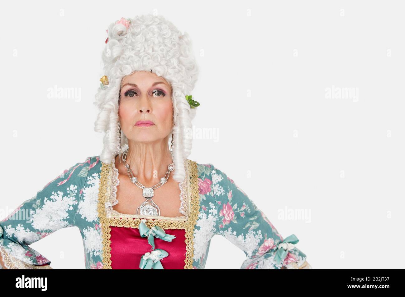 Portrait of confident senior queen over gray background Stock Photo - Alamy