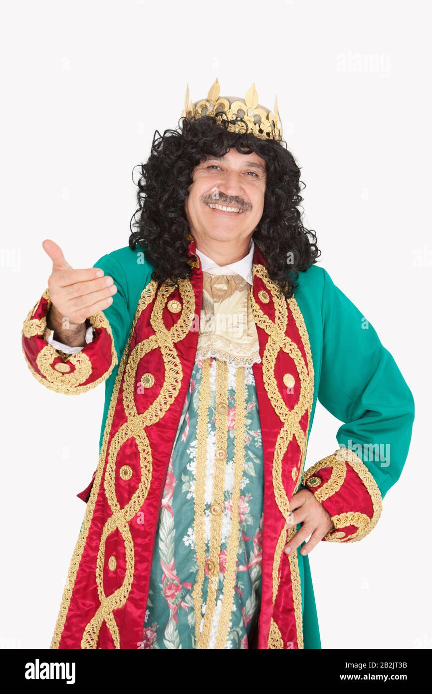 Portrait of happy king with hand gesture over gray background Stock ...