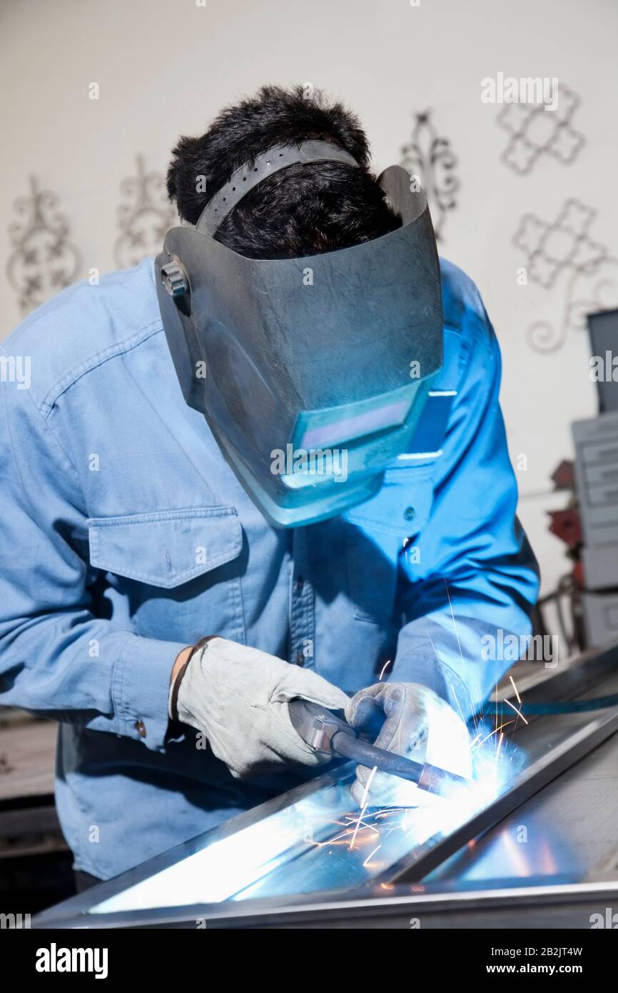 Young man welder wearing hi-res stock photography and images - Alamy