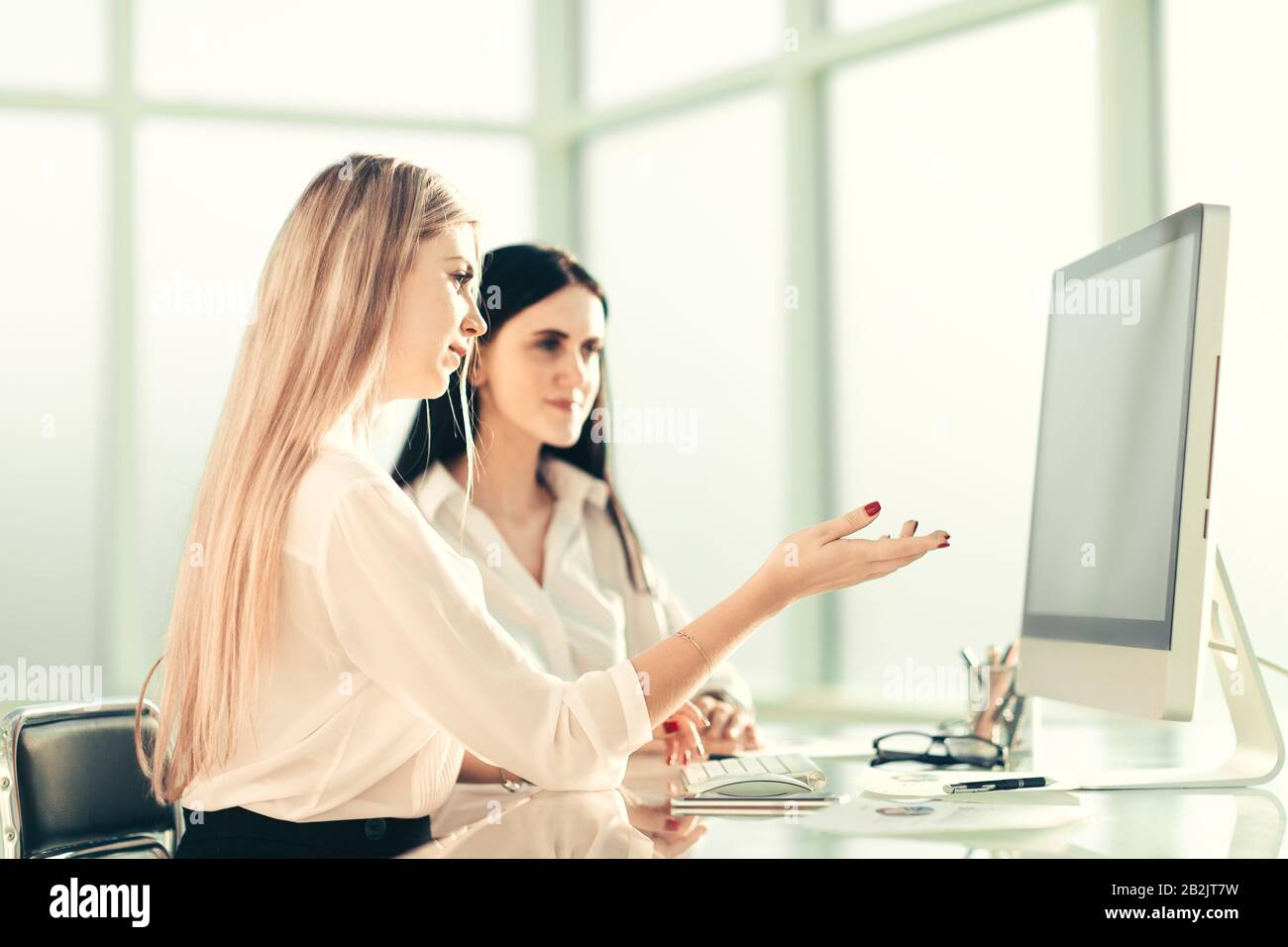 two employees sitting at the office Desk Stock Photo - Alamy