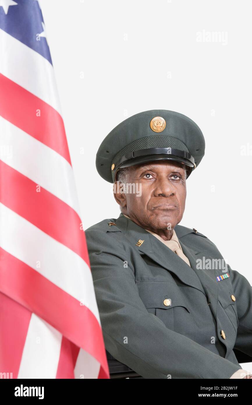 Senior male US military officer with American flag against gray ...