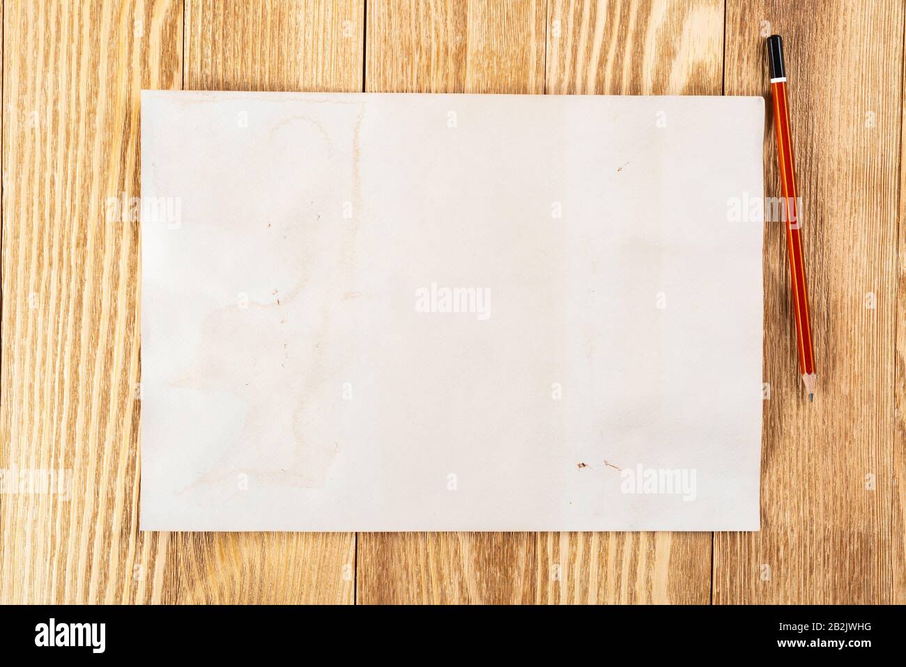 Sheet of paper lying on wooden table Stock Photo - Alamy