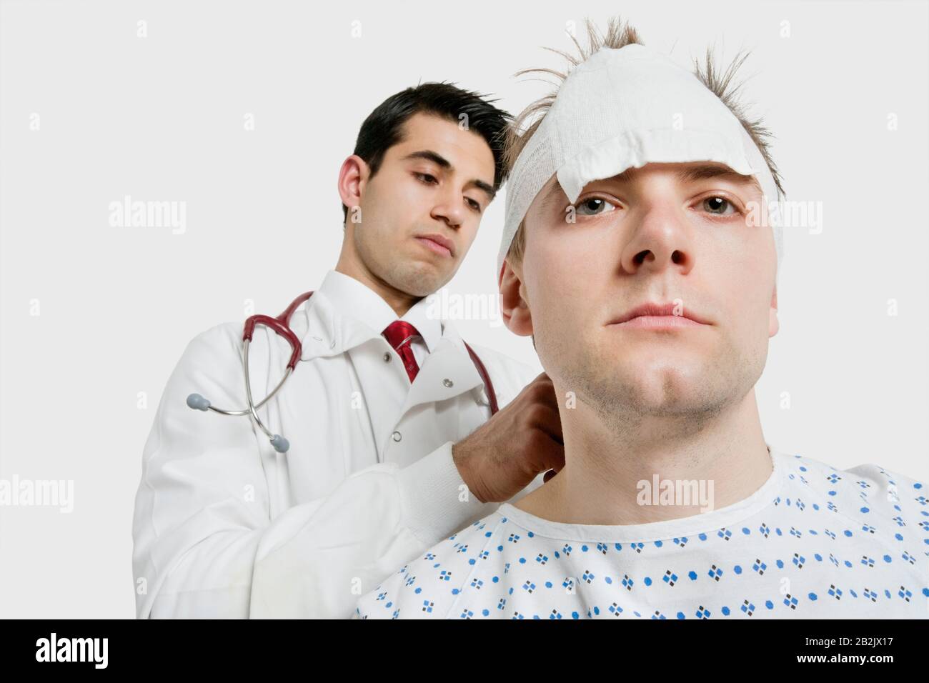 Indian male doctor treating male patient Stock Photo - Alamy