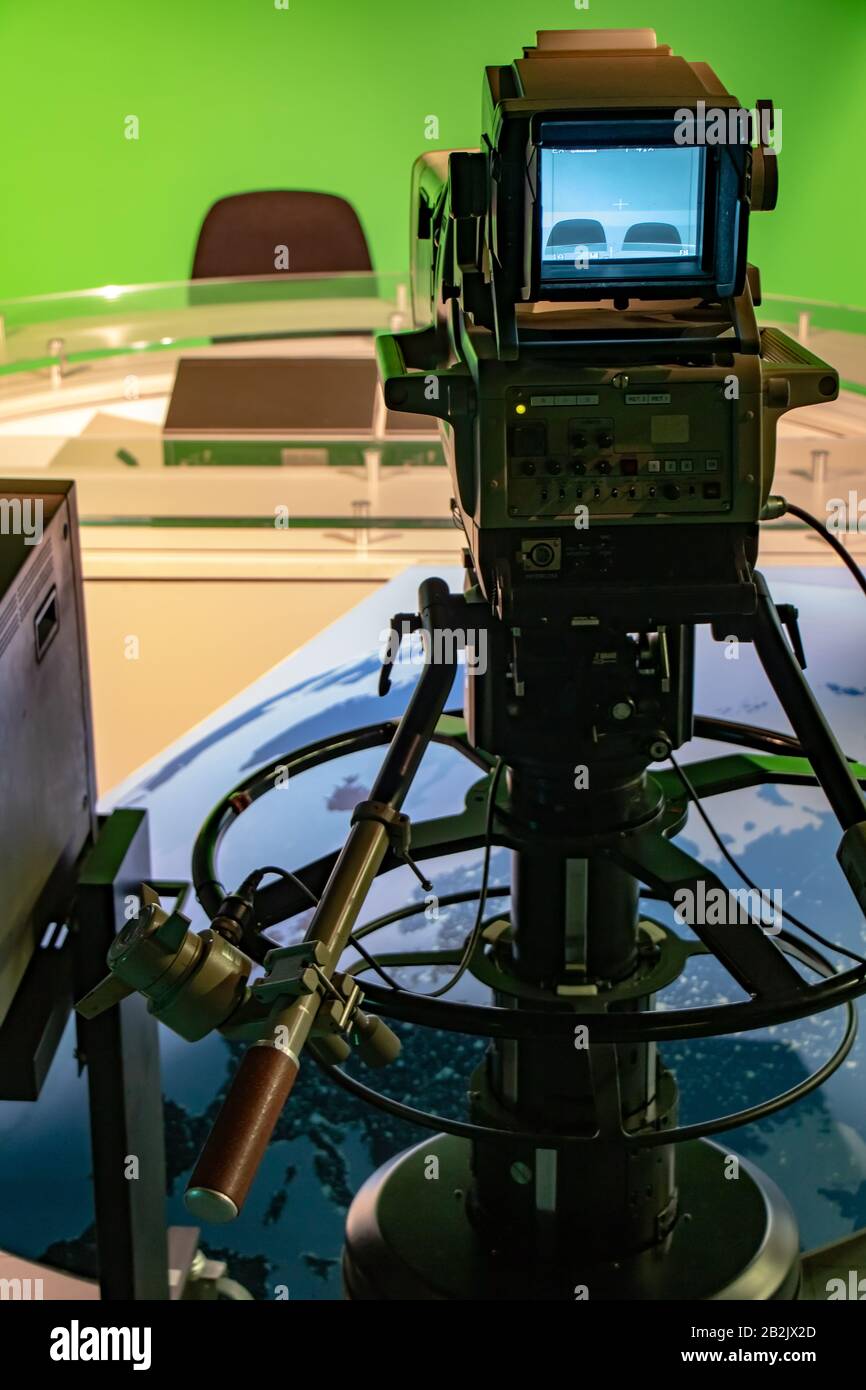 TV studio with professional camera aiming at empty seat, focus on ...