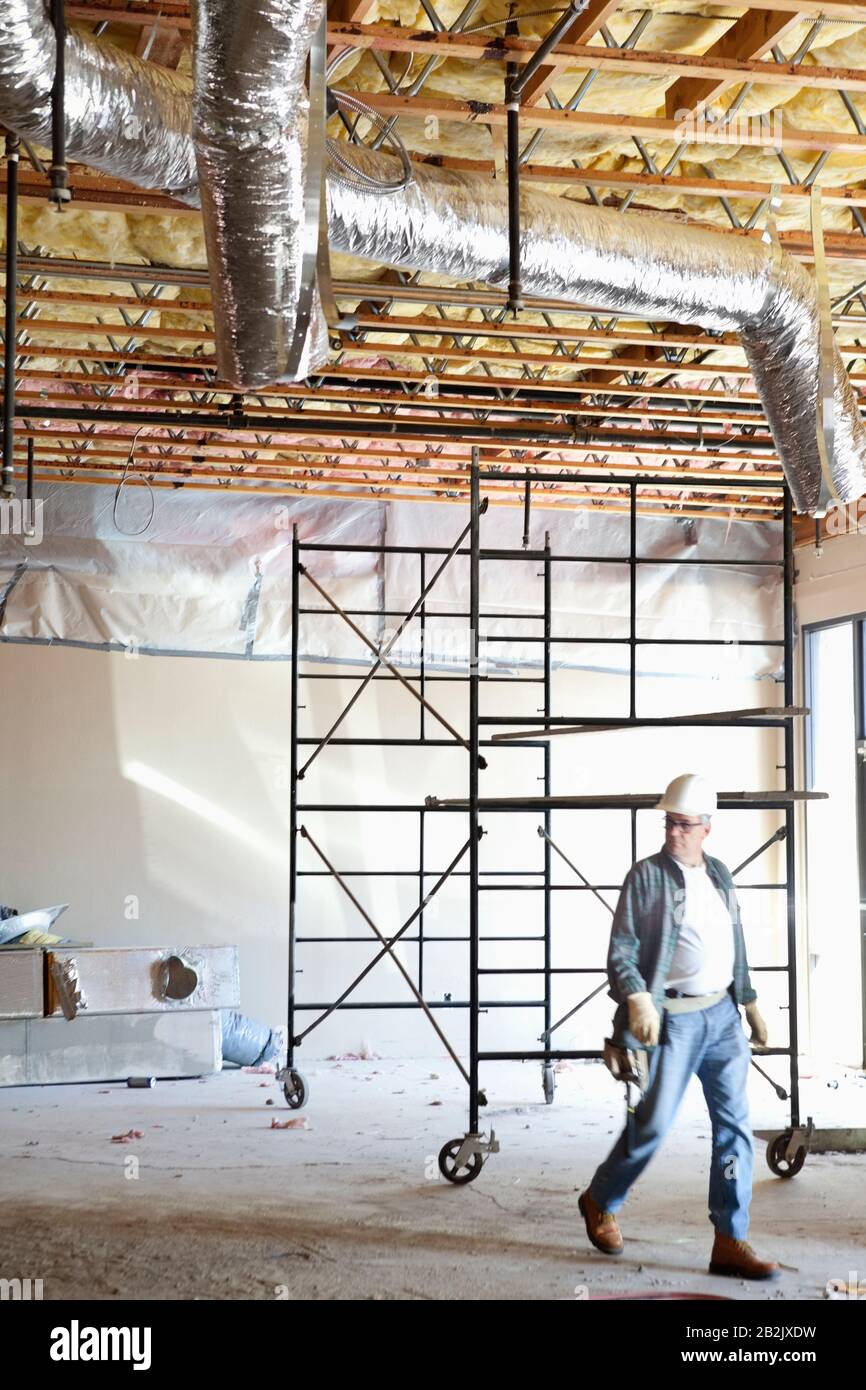 Front view of contractor walking at construction site Stock Photo - Alamy