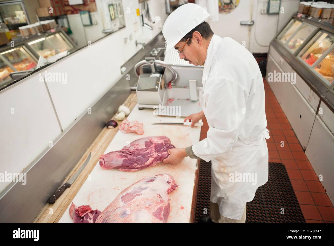 Butcher holding steak in store Stock Photo - Alamy