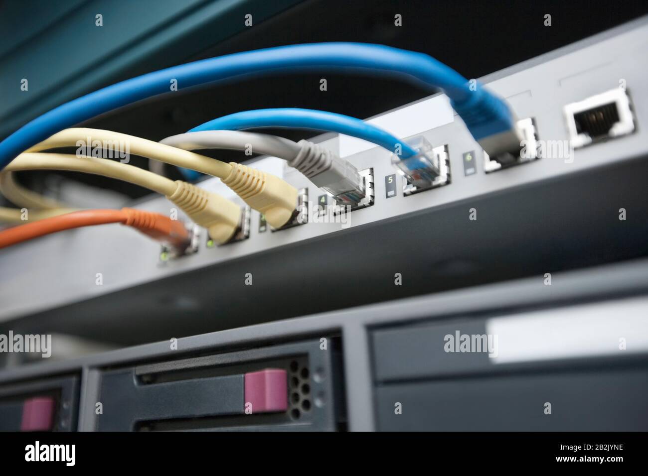 Close-up of data cable plug connected to servers in computer lab Stock ...