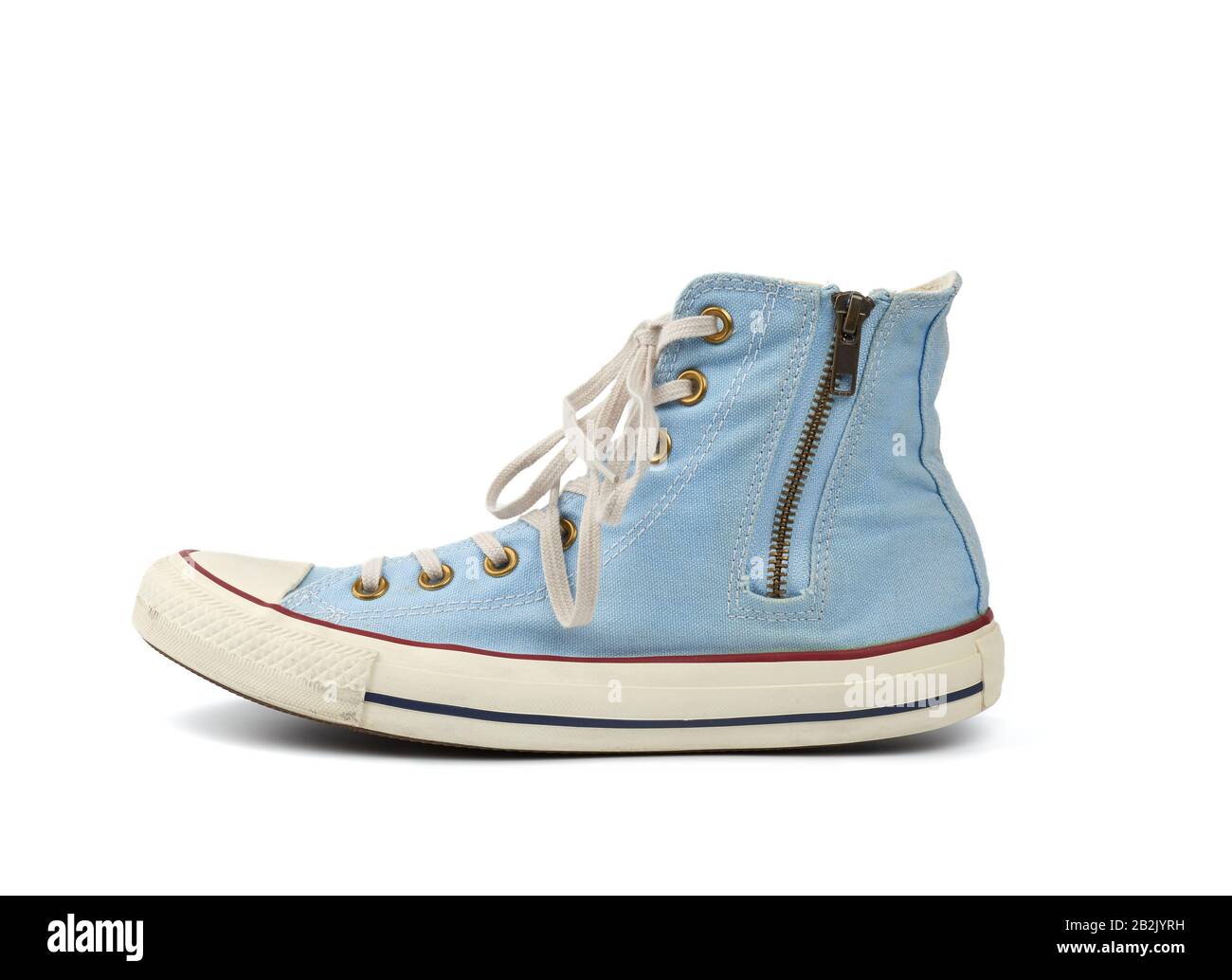 worn light blue sneaker with tied white laces and an iron zipper ...