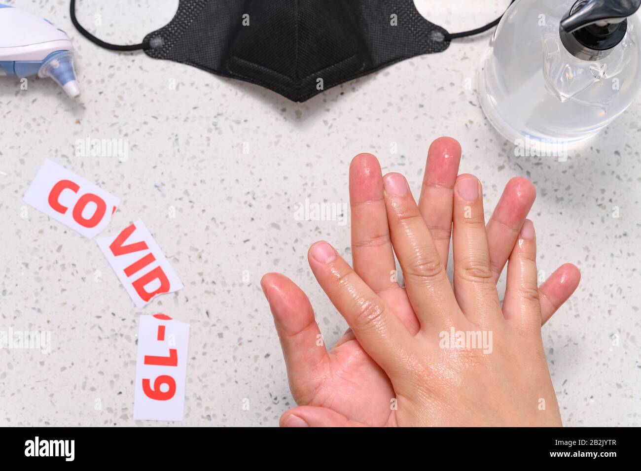 washing hands with instant hand sanitizer and torn out covid 19 and ...