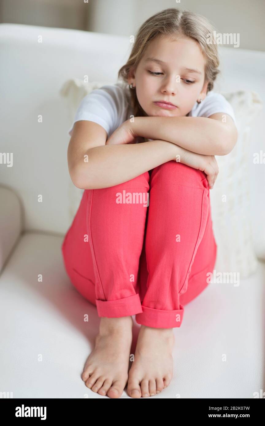 Sad Girl Sitting On Sofa Stock Photo Alamy