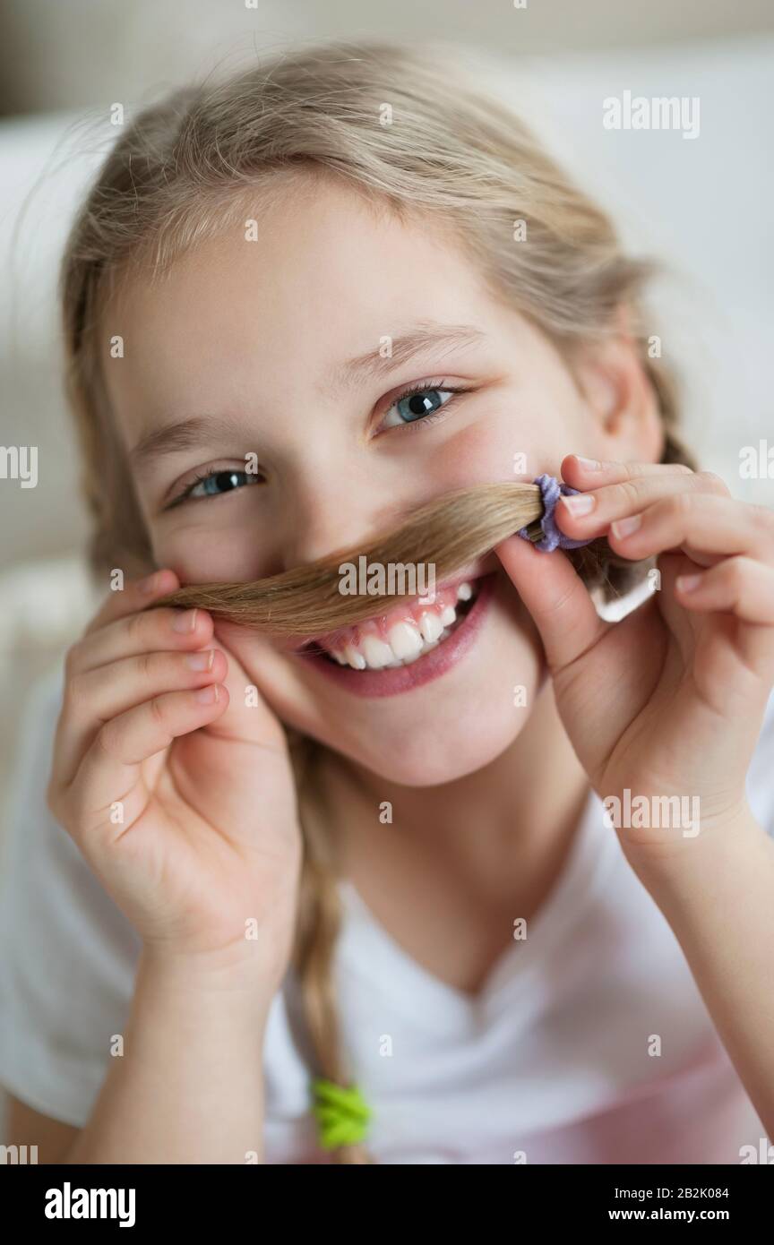 Girl making mustache with hair Stock Photo - Alamy