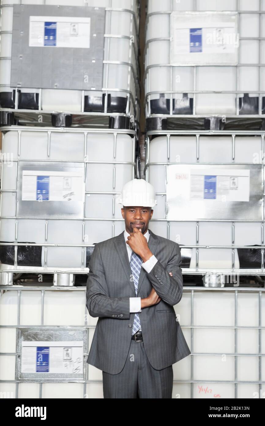 Confident African American male contractor standing in manufacturing ...