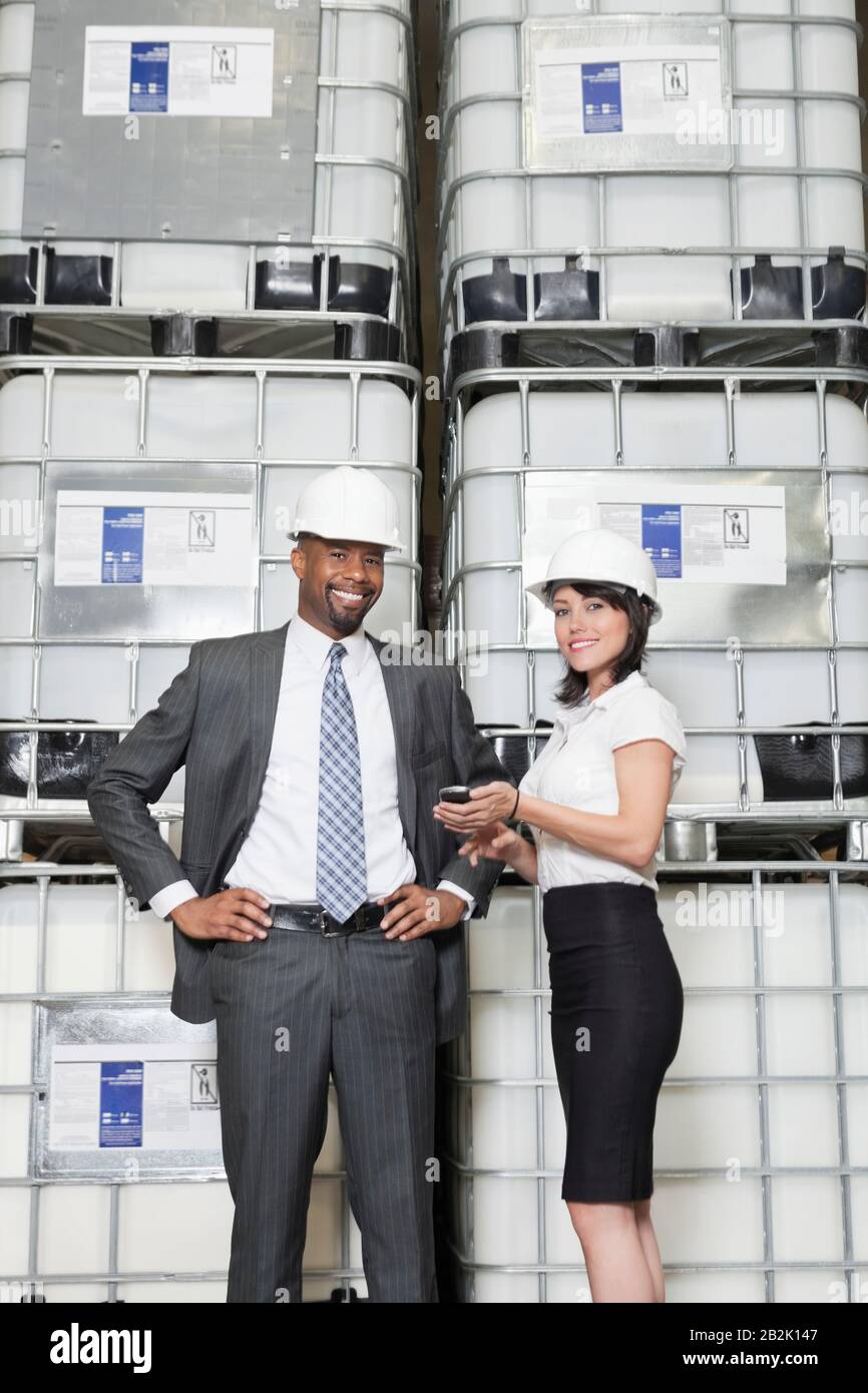 Portrait of multiethnic business colleagues standing in manufacturing ...