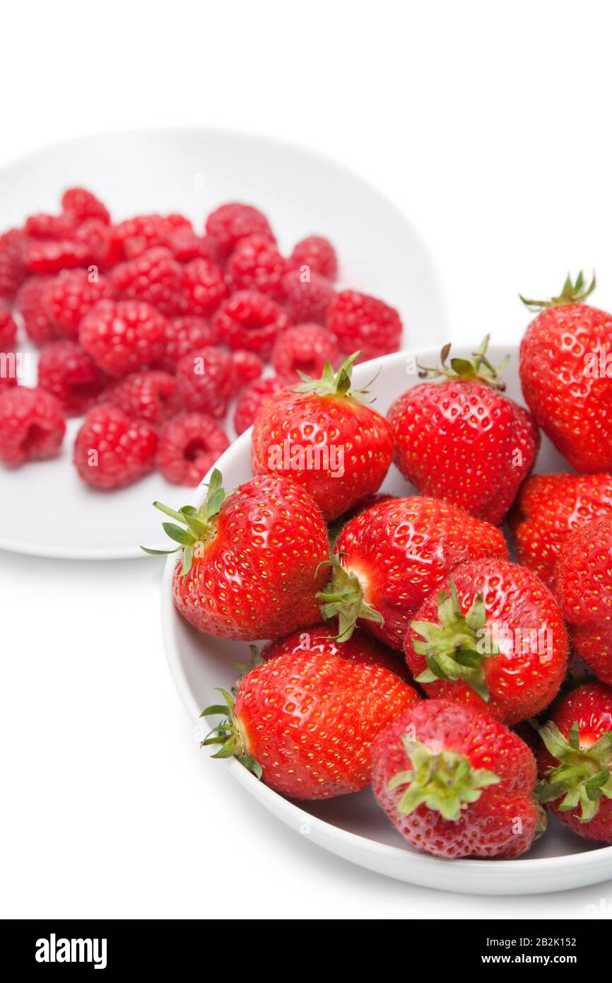Strawberries and raspberries over white background Stock Photo - Alamy