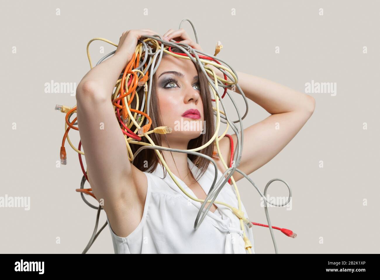 Woman with tangled cables hi-res stock photography and images - Alamy