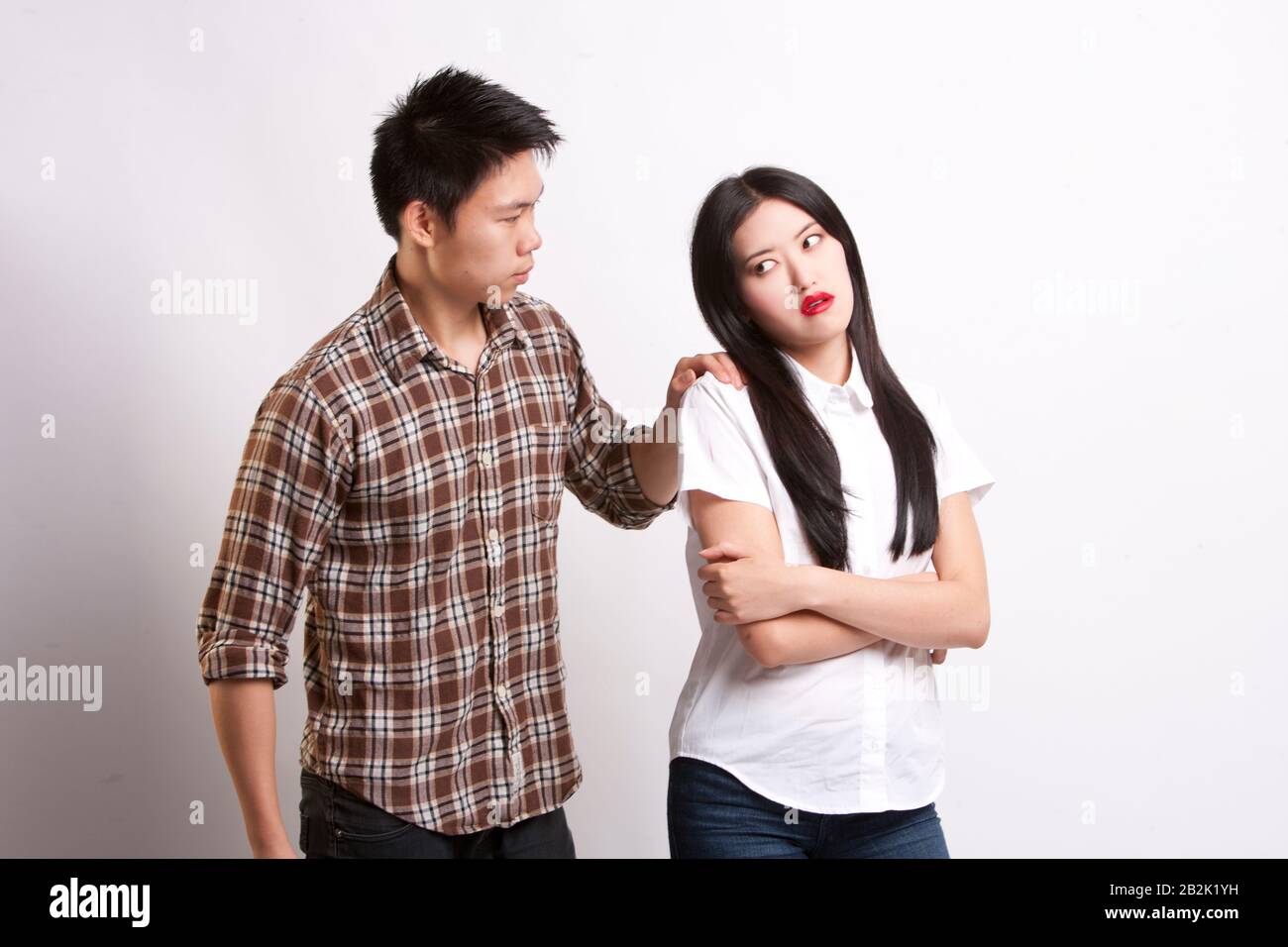 Young man convincing beautiful woman over white background Stock Photo ...