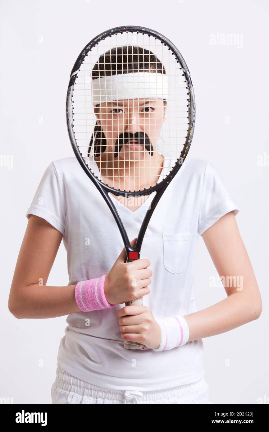 Portrait of young woman with a fake mustache holding tennis racket in ...
