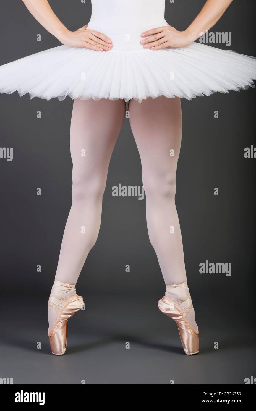 Low section of young female ballet dancer wearing white tutu and ballet ...