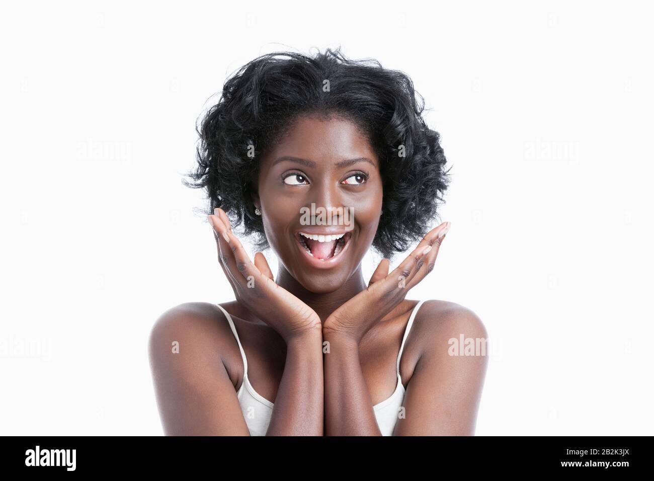 Portrait of a surprised young woman shouting over white background ...
