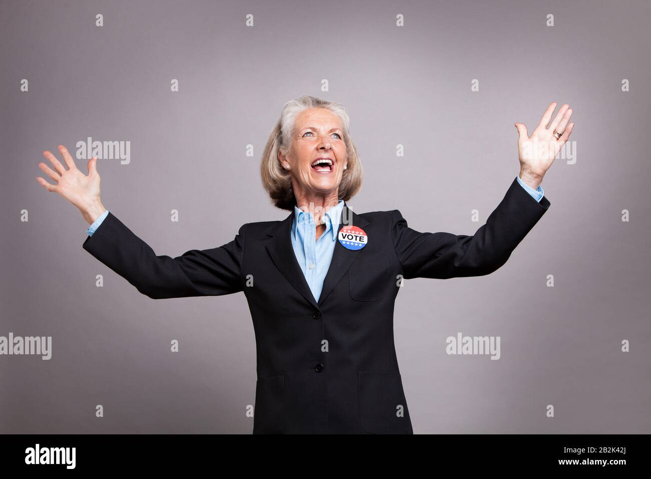 Senior female politician with arms in the air Stock Photo - Alamy
