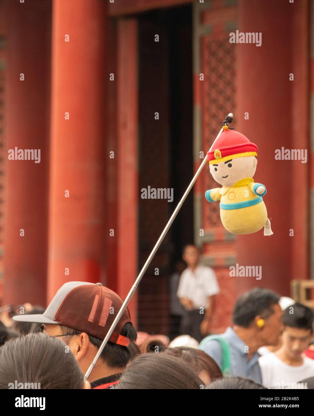 mascot on stick with crowds of Chinese tourists at the Forbidden City ...