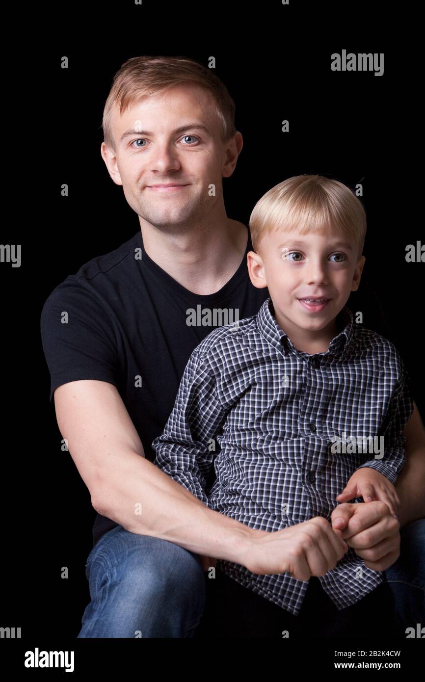young boy with his father posing in the studio Stock Photo - Alamy