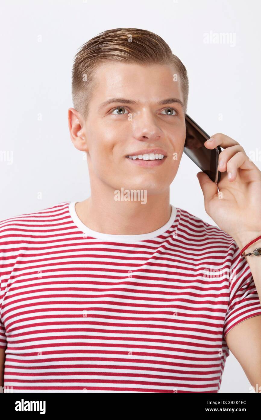 Happy young man using cell phone against white background Stock Photo ...