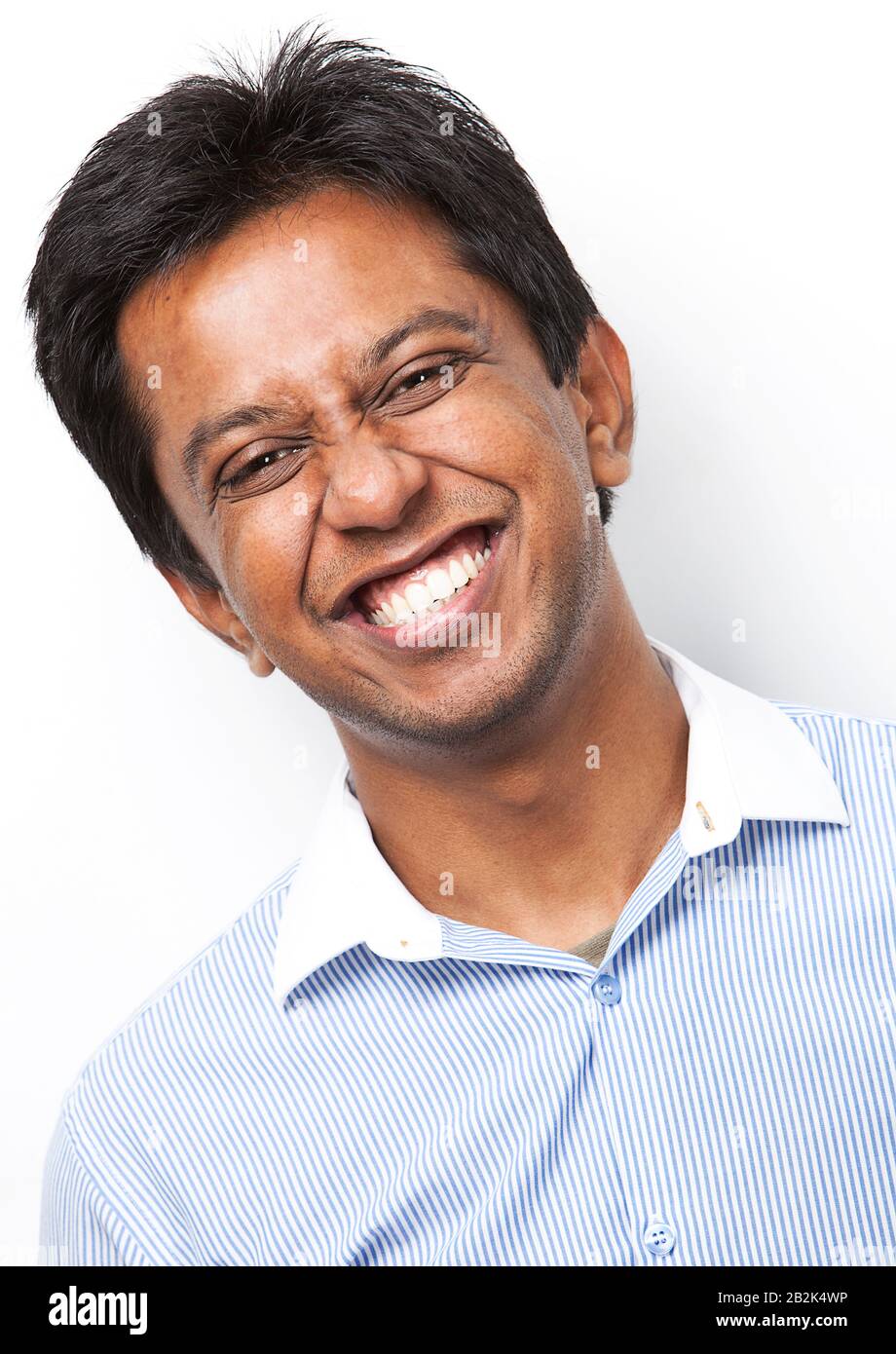 Portrait of happy young Indian man against white background Stock Photo ...