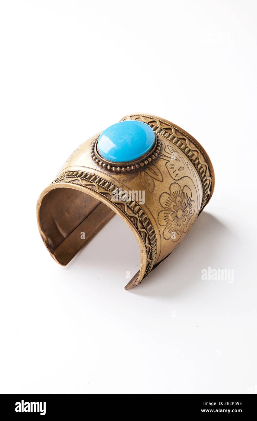 Blue gem on traditional bracelet over white background Stock Photo - Alamy