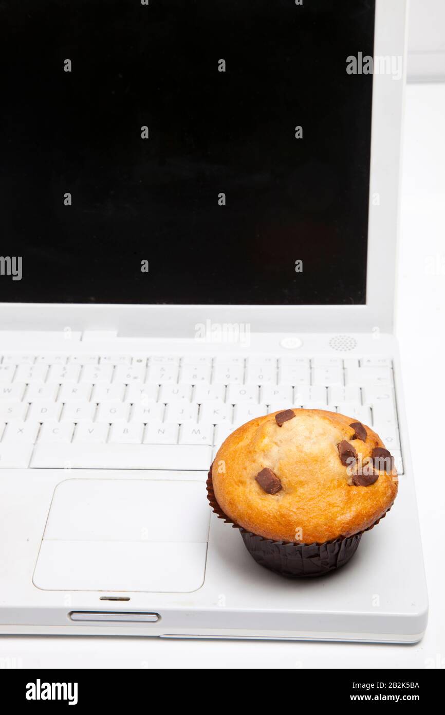 Close-up of cupcake and laptop Stock Photo - Alamy