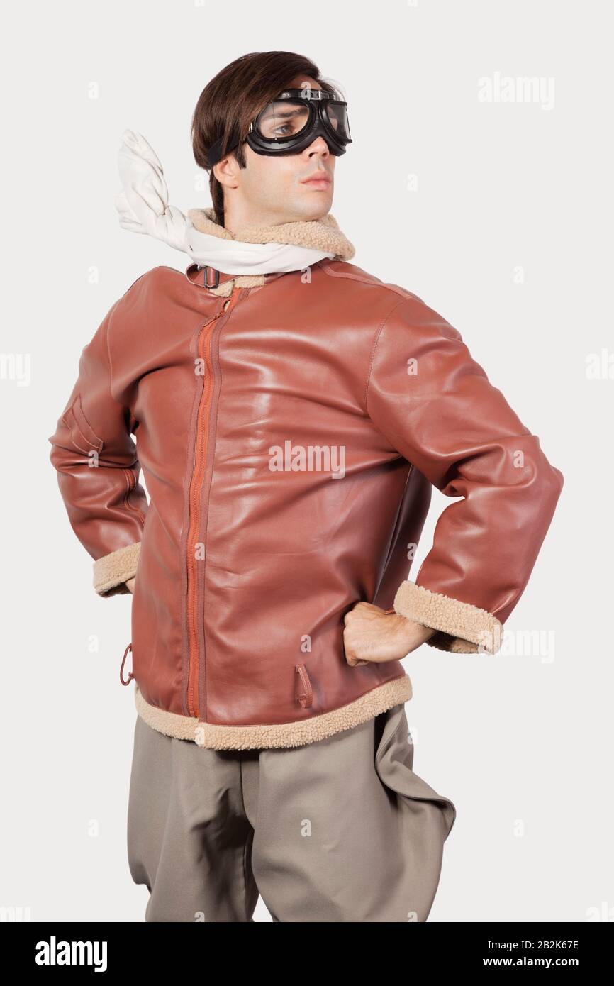 Young man in old-fashioned pilot costume against gray background Stock ...