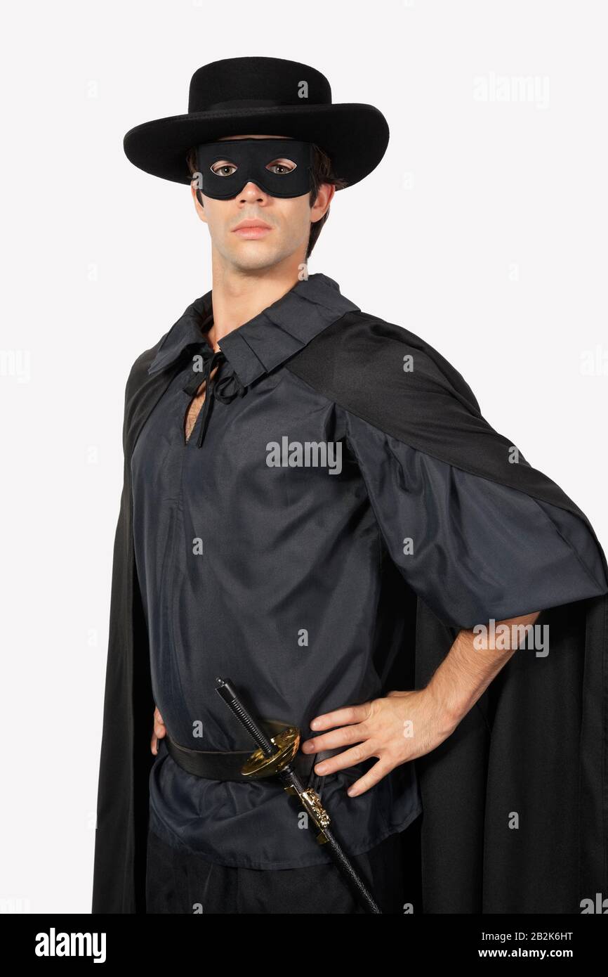 Portrait of young man dressed as Zorro against gray background Stock ...