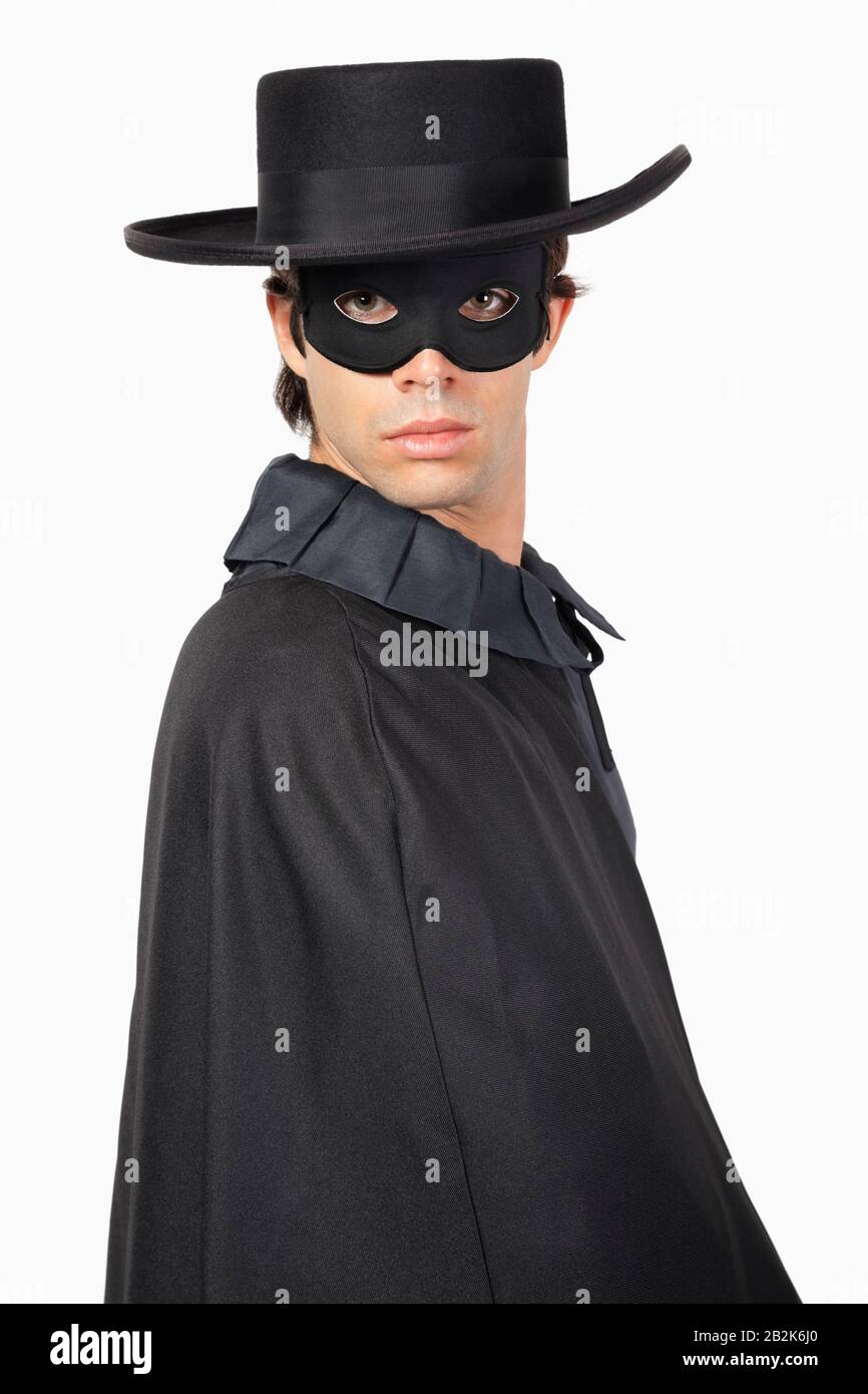 Portrait of man dressed as Zorro over gray background Stock Photo - Alamy